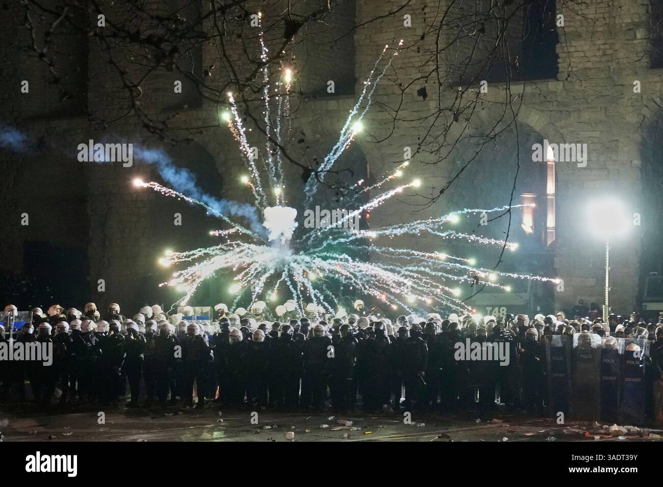 FILE - Fireworks thrown by protesters explode over riot police during a ...