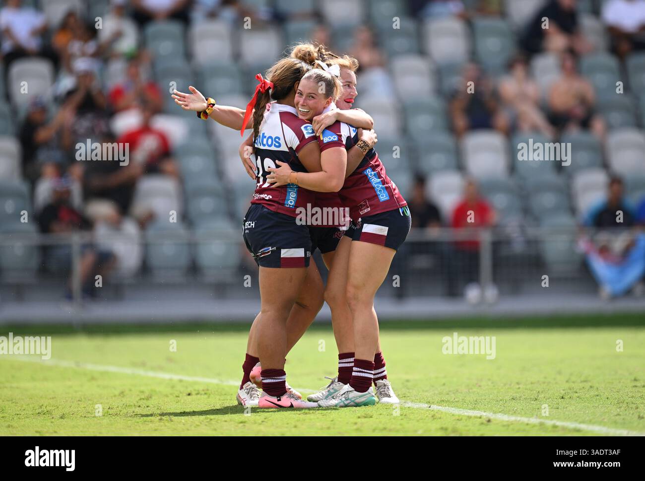 Shalom Sauaso of the Reds (left) reacts with Layne Morgan and Caitlin ...
