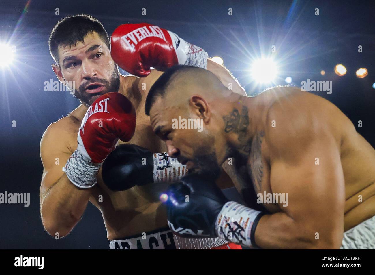 Liam Talivaa (R) throws a punch in the Australian Heavyweight Title ...