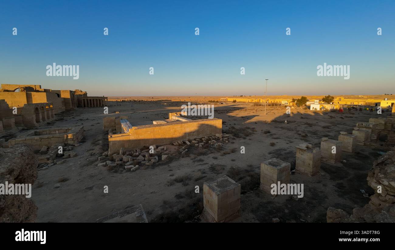 Ancient ruins in a desert landscape under a clear blue sky, with ...
