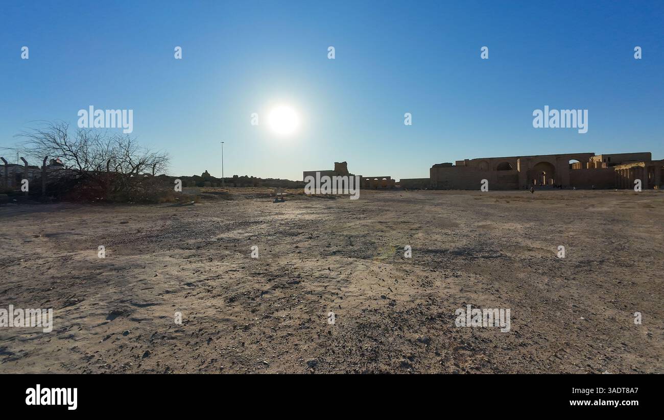 A barren landscape with a clear blue sky and the sun shining brightly ...