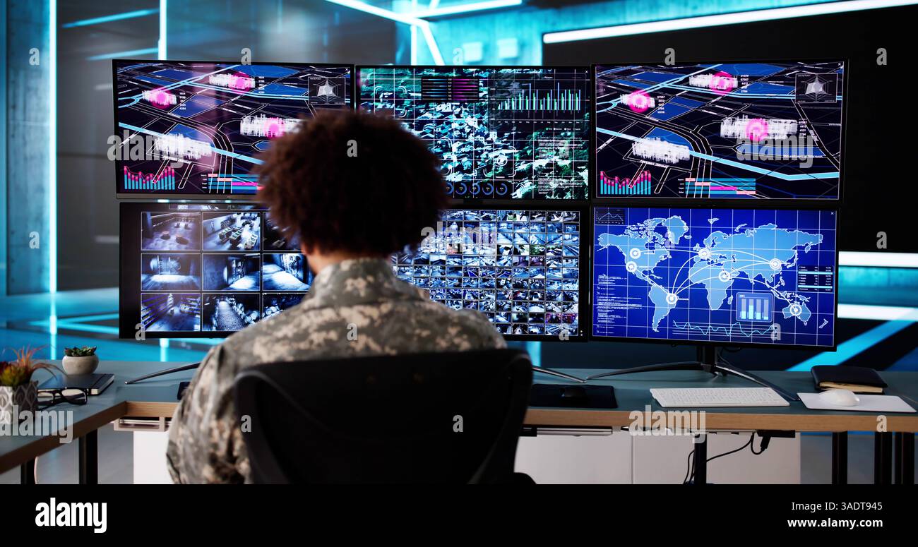 African man monitors real-time surveillance data on air reconnaissance ...