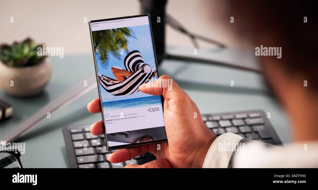 Tech-savvy African American man scrolls through social media on phone ...