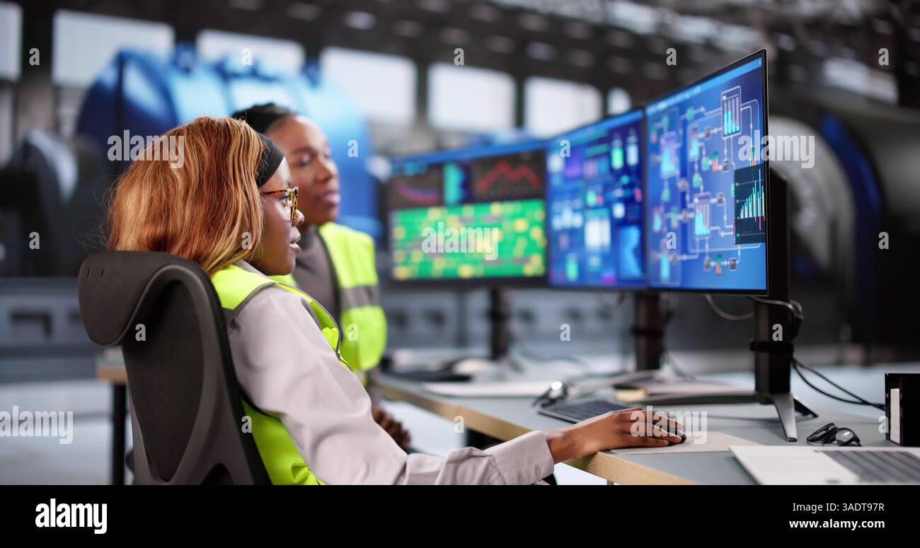 African-American woman managing gas turbine at power plant's control ...