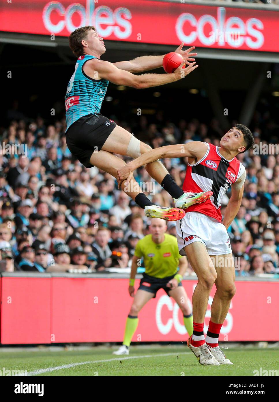 Mitch Georgiades of the Power flies for a mark over Anthony Caminiti of ...