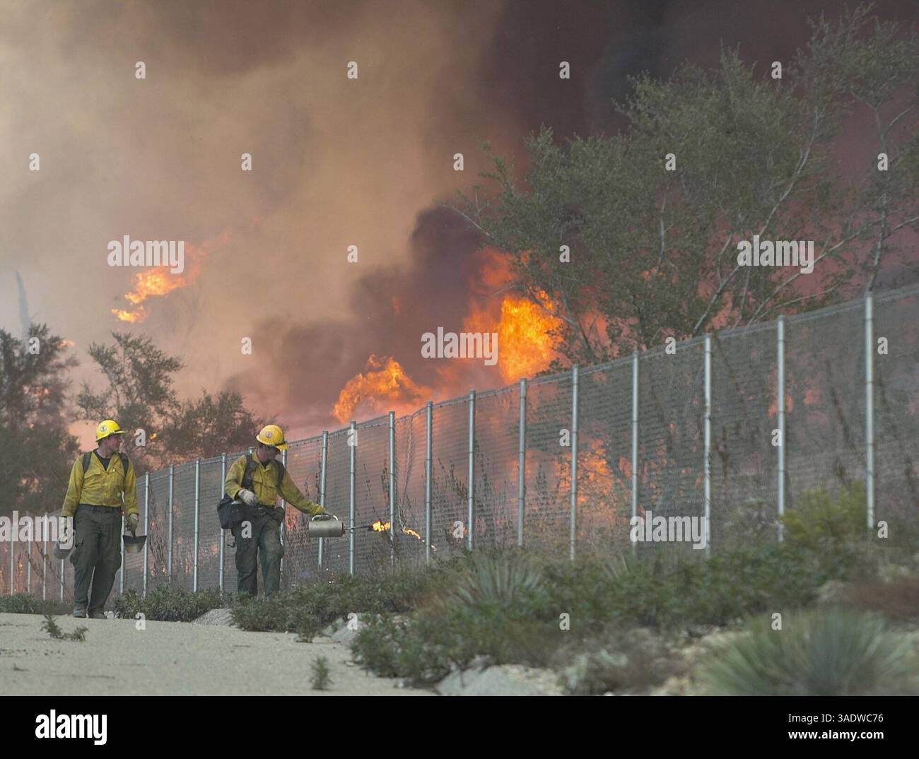 Oct 24, 2003; Rancho Cucamonga, CA, USA; Firefighters light backfires ...