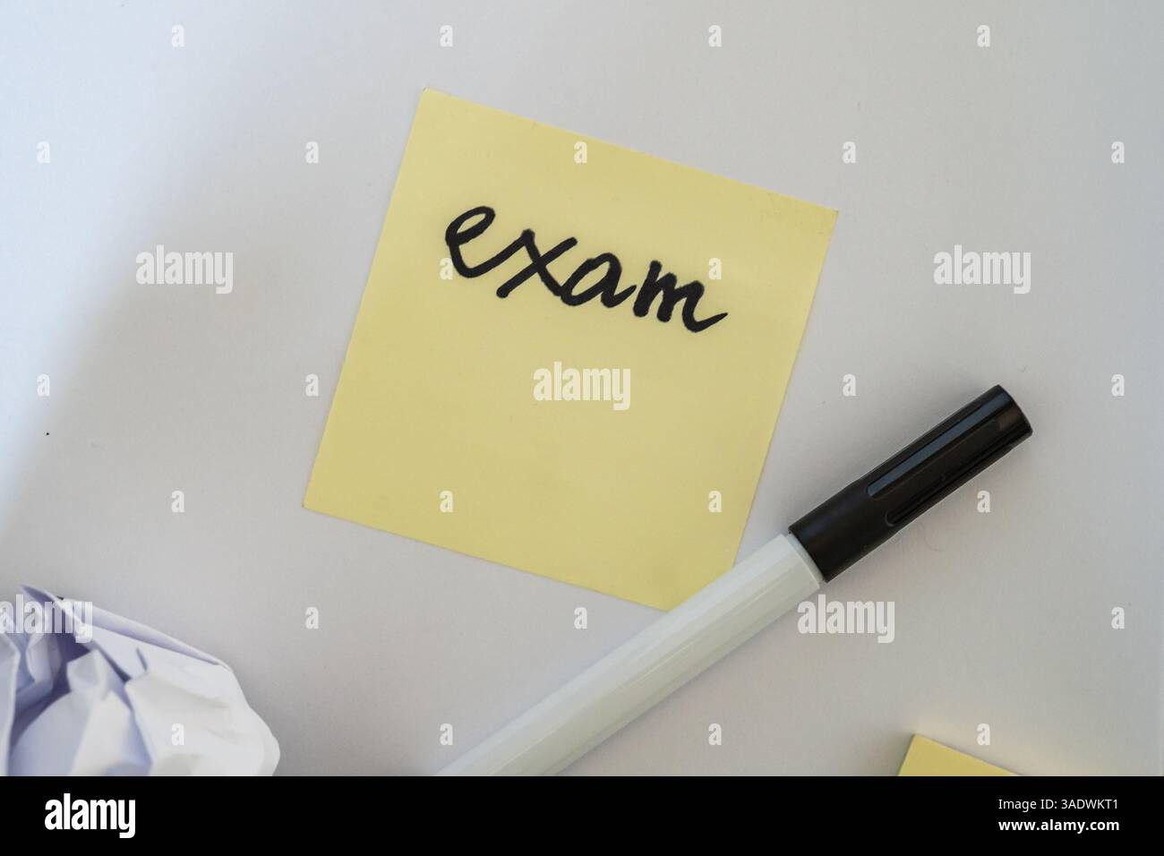 word exam written with black pen on paper - a reminder of school ...