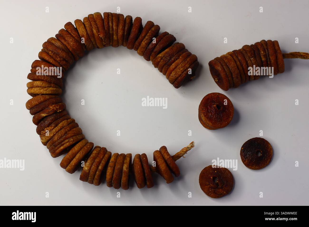 Dried figs on a string, showing rich texture and sweetness Stock Photo ...
