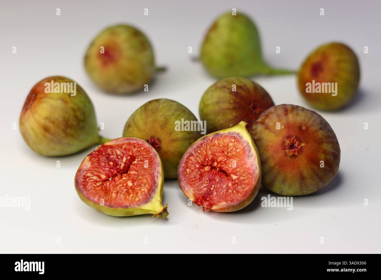 Fresh figs on a white background, showing soft texture and rich color ...