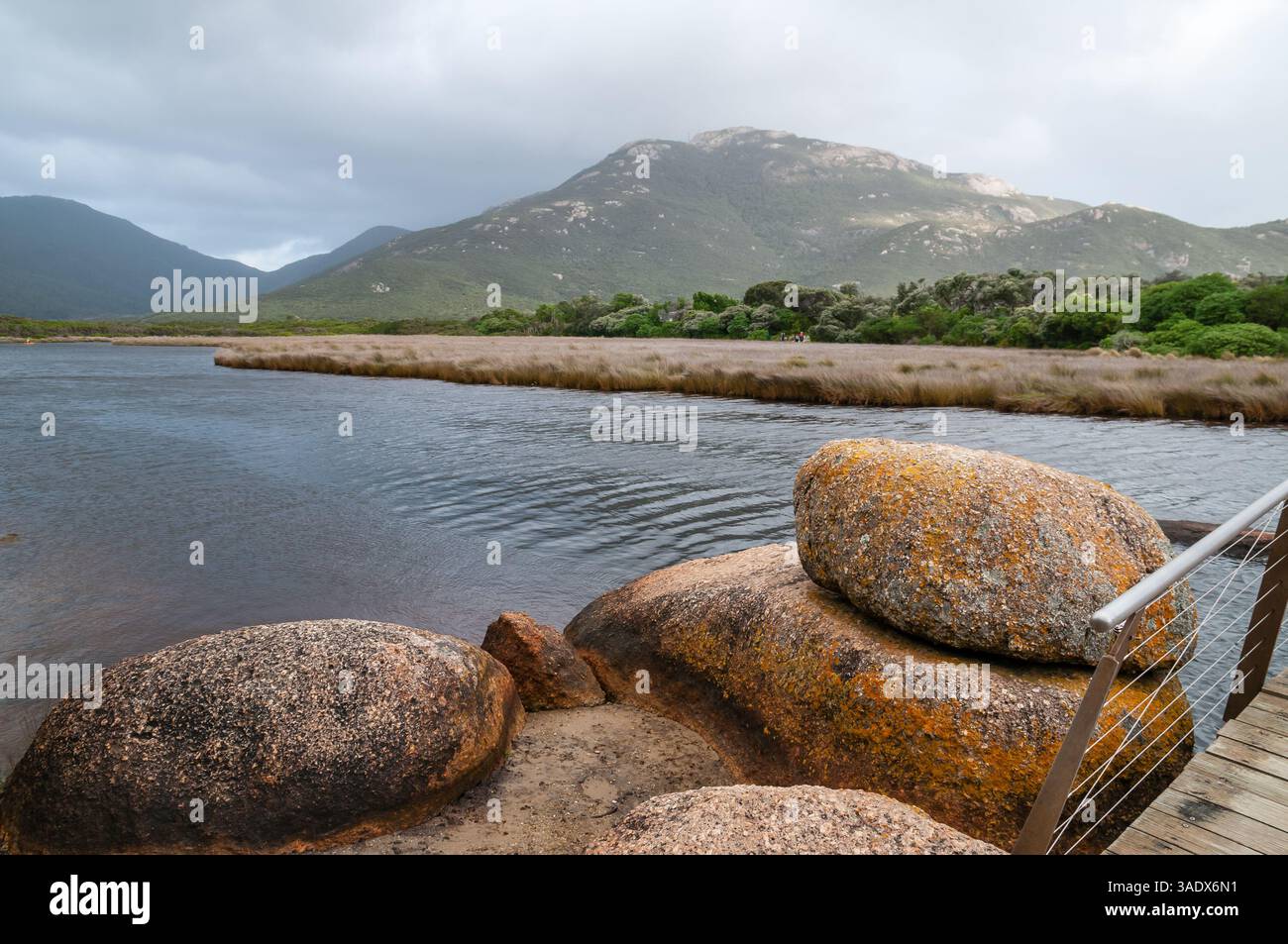 Large rocks and water with mountain backdrop, Tidal River, Wilsons ...