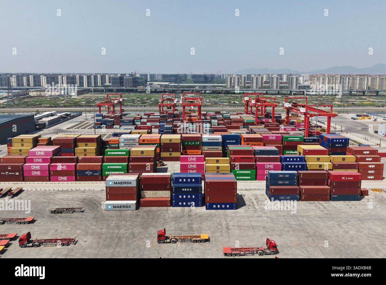 HANGZHOU, CHINA - APRIL 6, 2025 - Bridge cranes are used to load and ...