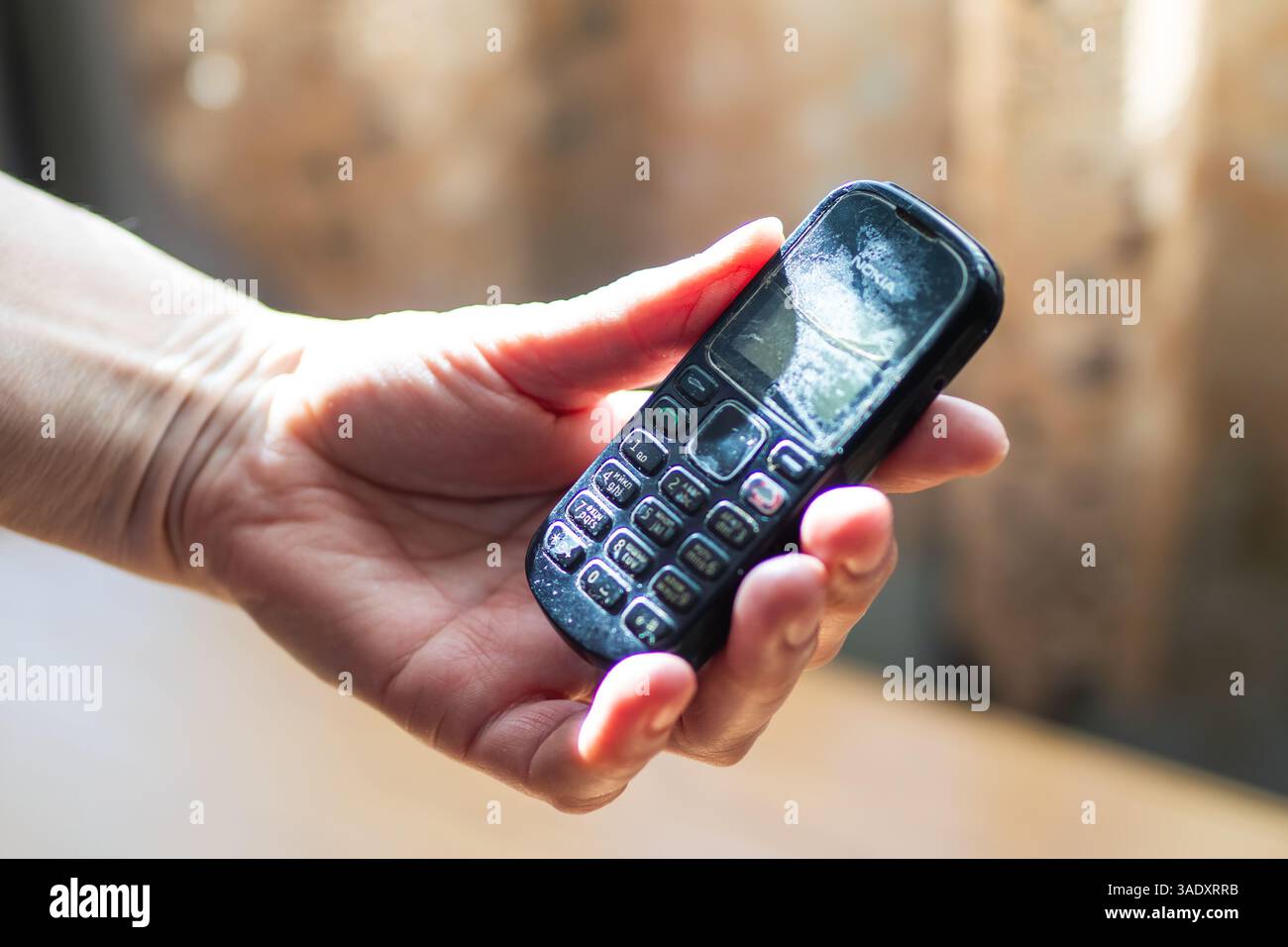 Belarus, Minsk - 09.03.2025: A person is currently holding an older ...