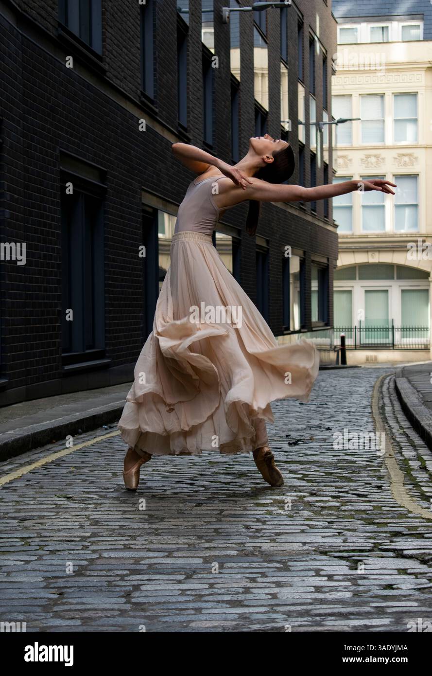 Ballerina dancing en pointe against an urban backdrop, elegant and ...