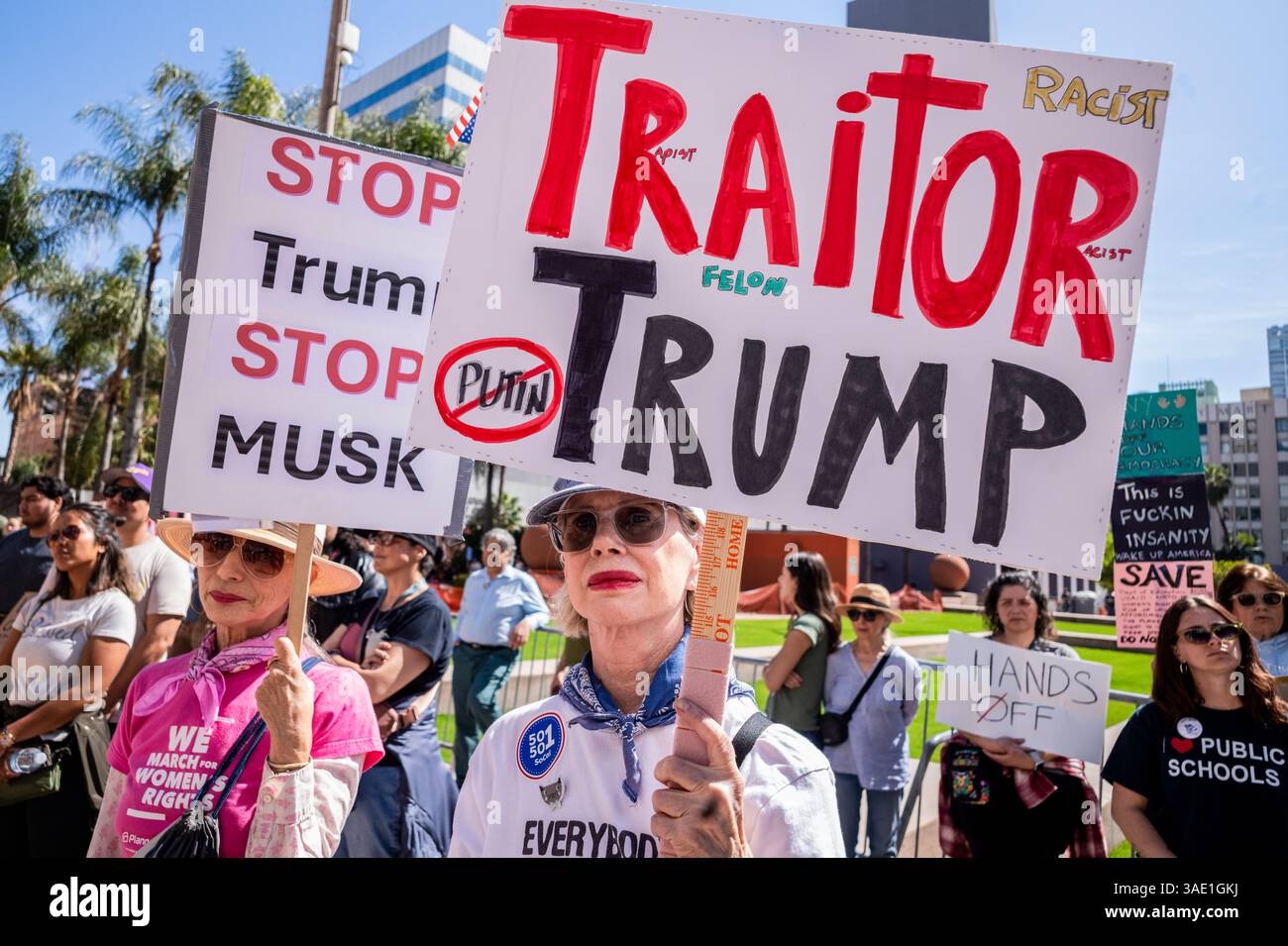 Protesters hold placards expressing their opinion in a march and ...