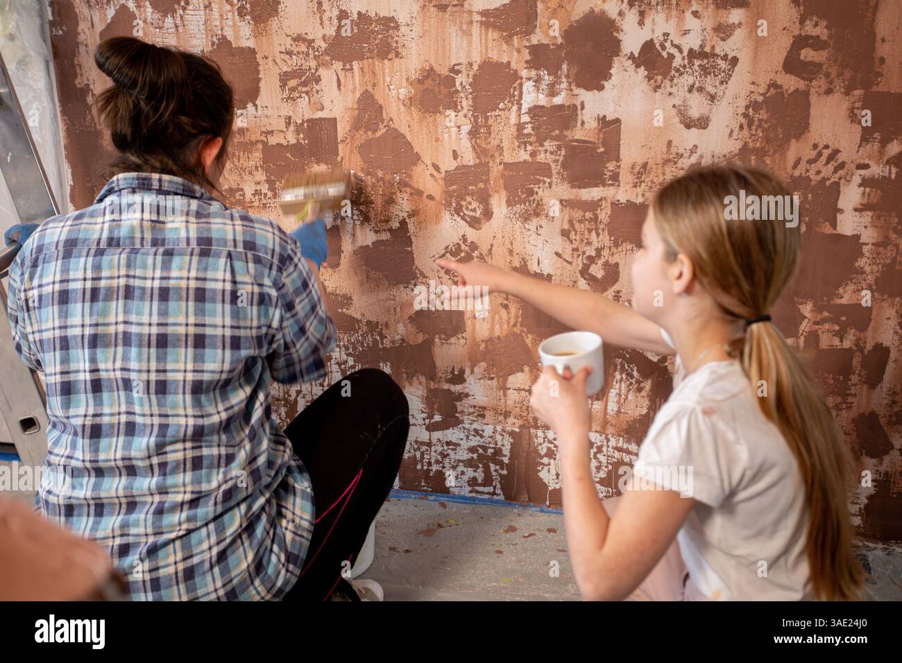 Family Renovation Day Engaging in Painting Together as a Fun and ...