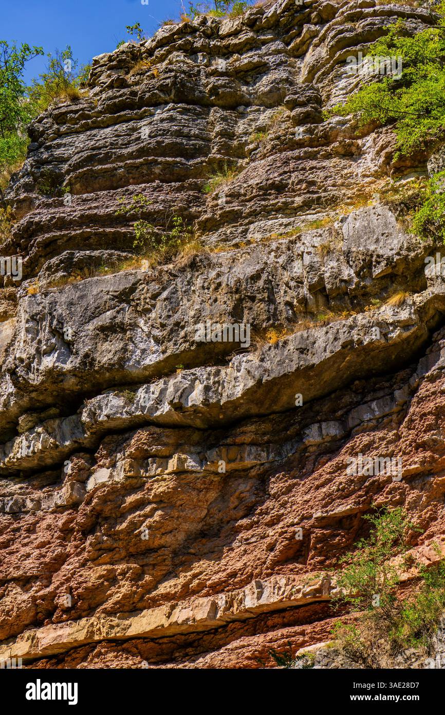 Layers of vibrant sedimentary rock rise majestically along the Boljetin ...