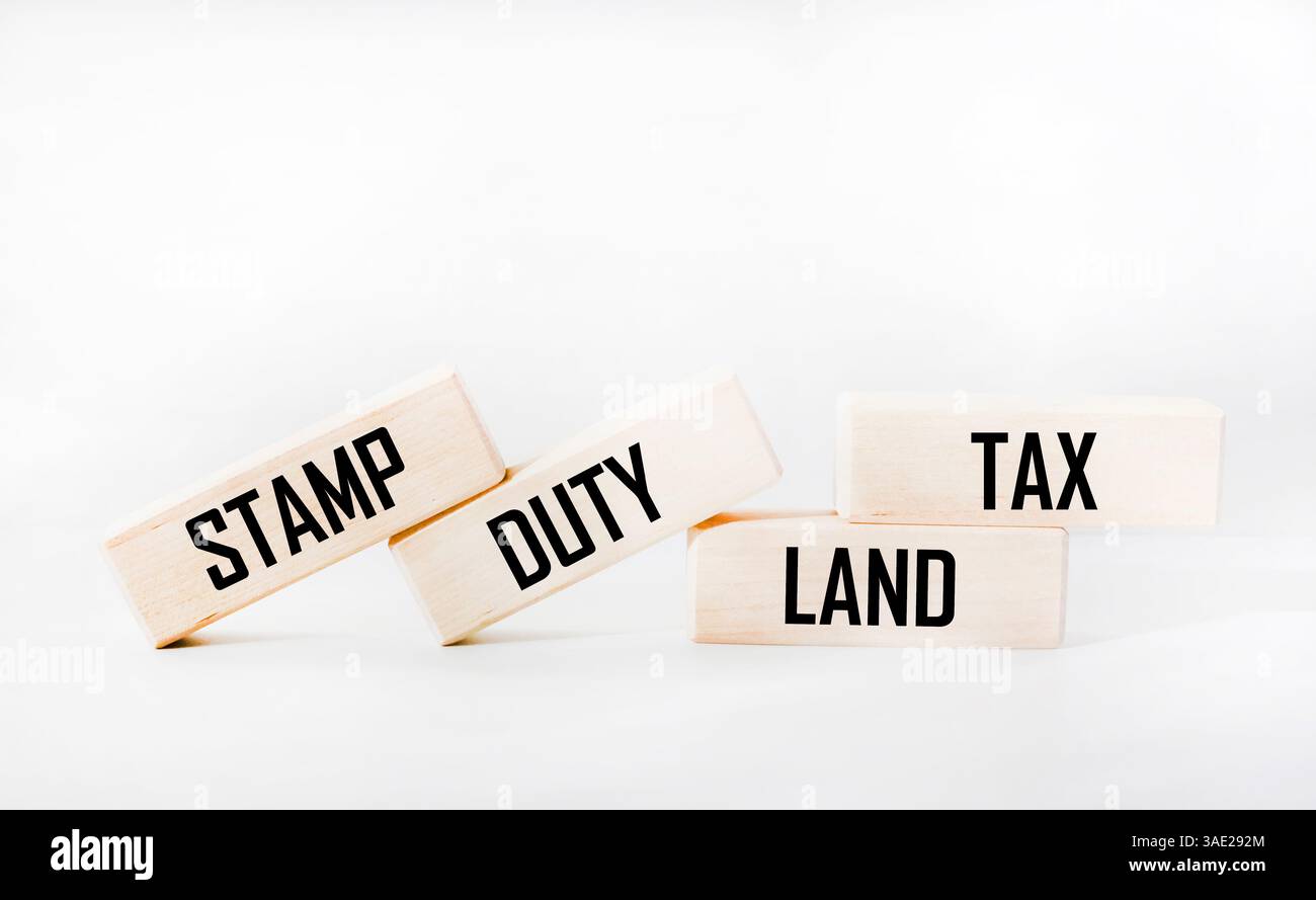 SDLT - Stamp duty, land tax, written on blocks on a white background ...