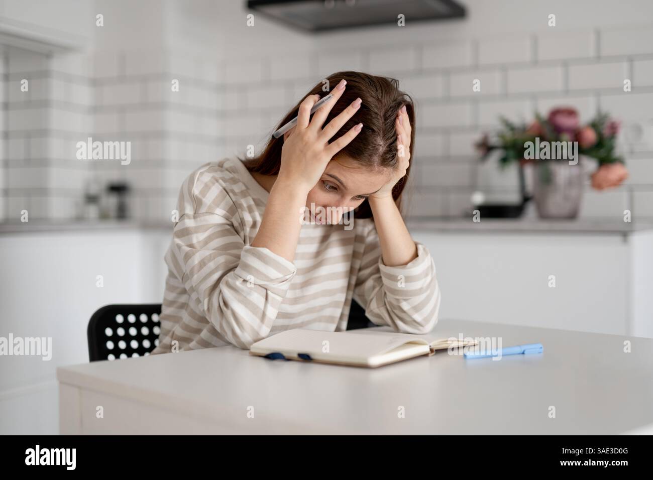 Girl Holding Head Over Difficult Homework Notes Stock Photo - Alamy