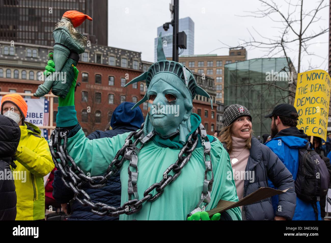 Statue of Liberty wrapped in iron chains walking through the crowd at ...