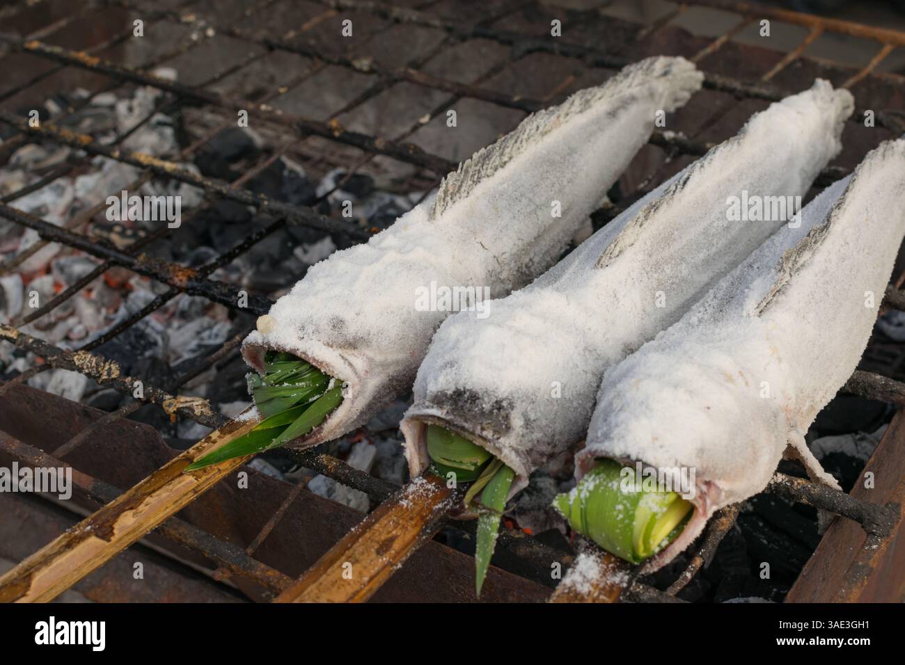 Salt-Crusted Grilled Snakehead fish grill on charcoal stove at market ...