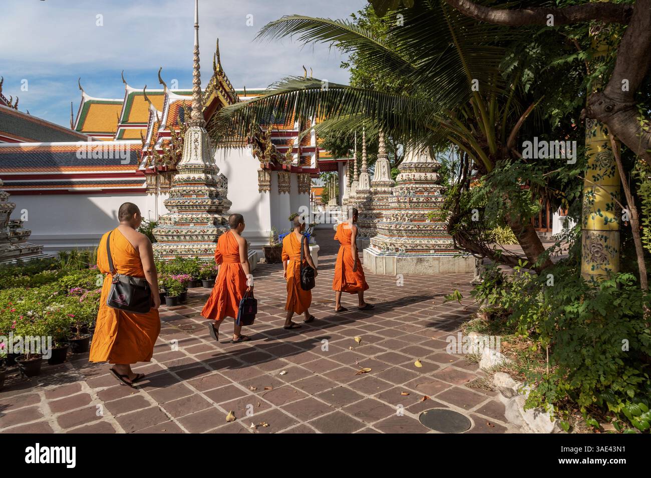Buddhist monks in the Temple of the Reclining Buddha, Wat Pho Temple ...