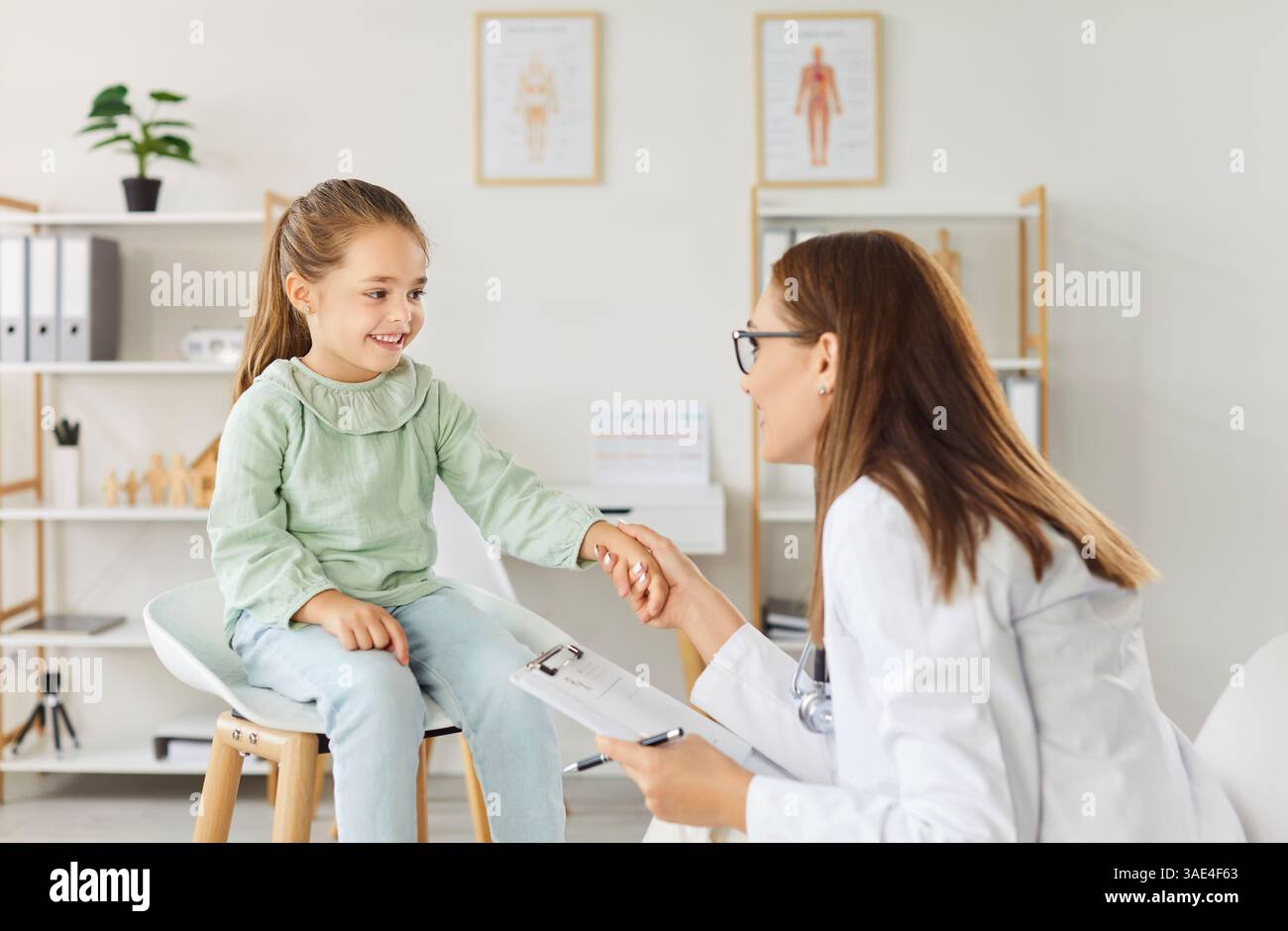 Caring pediatrician kind doctor meets child, examination, female ...