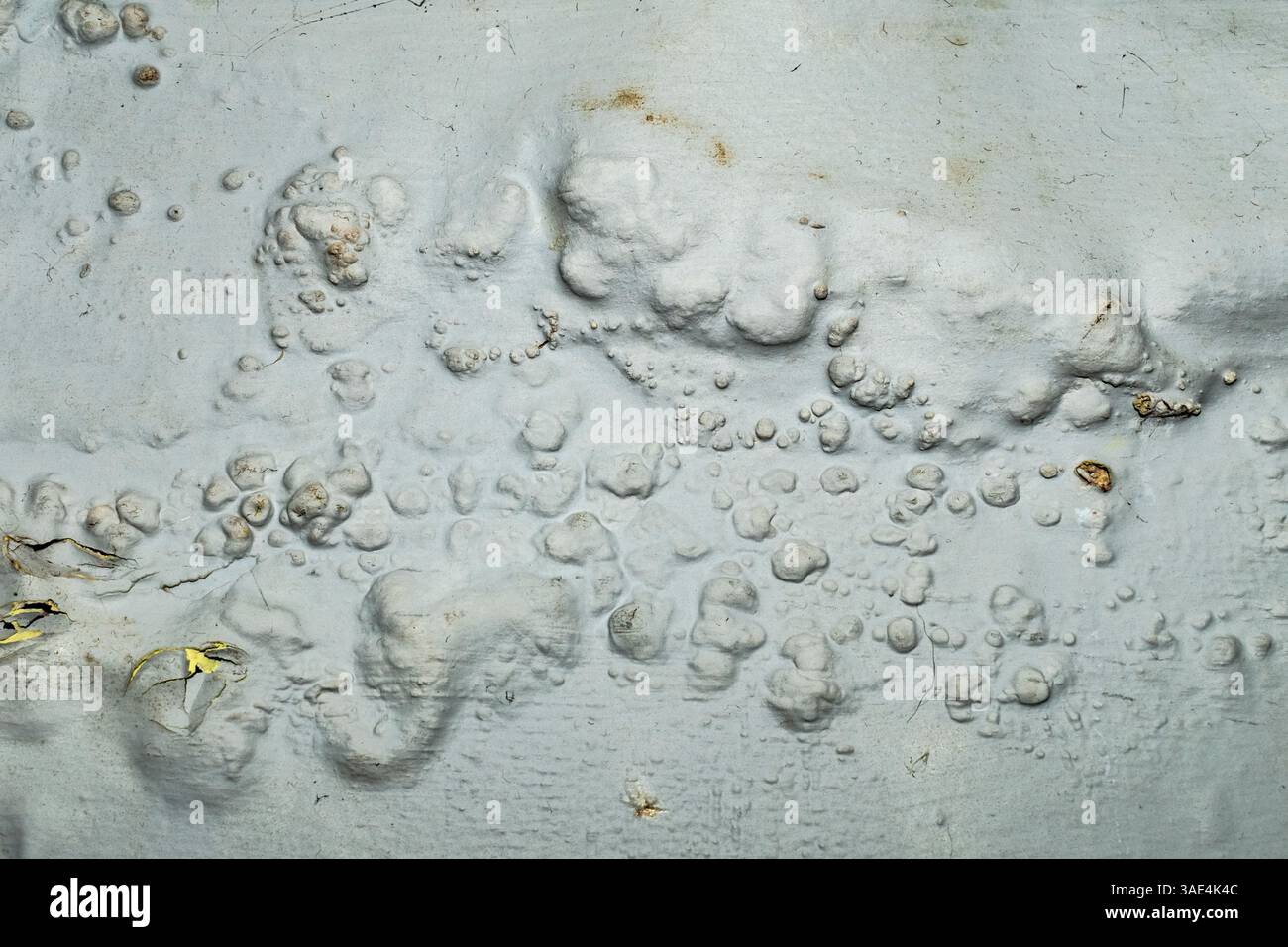 White damp swollen wall, textured background with moisture build-up in ...