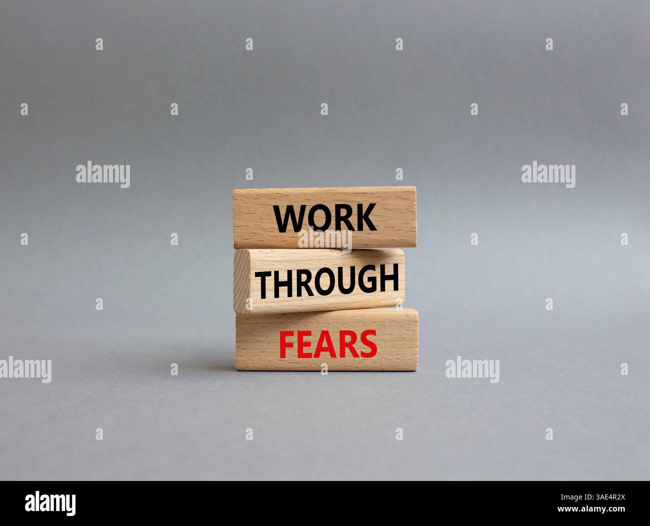 Work through fears symbol. Wooden blocks with words Work through fears ...