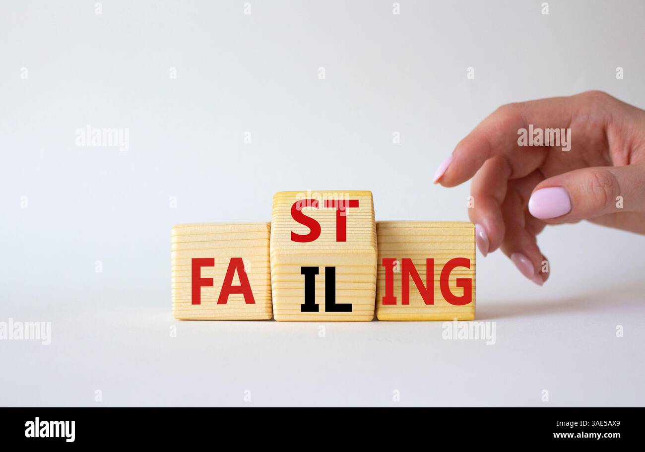 Fasting vs Failing symbol. Businessman hand points at wooden cubes with ...