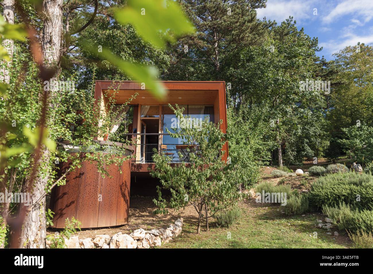 Wooden Cabin in Resort Surrounded by Lush Forest Stock Photo - Alamy