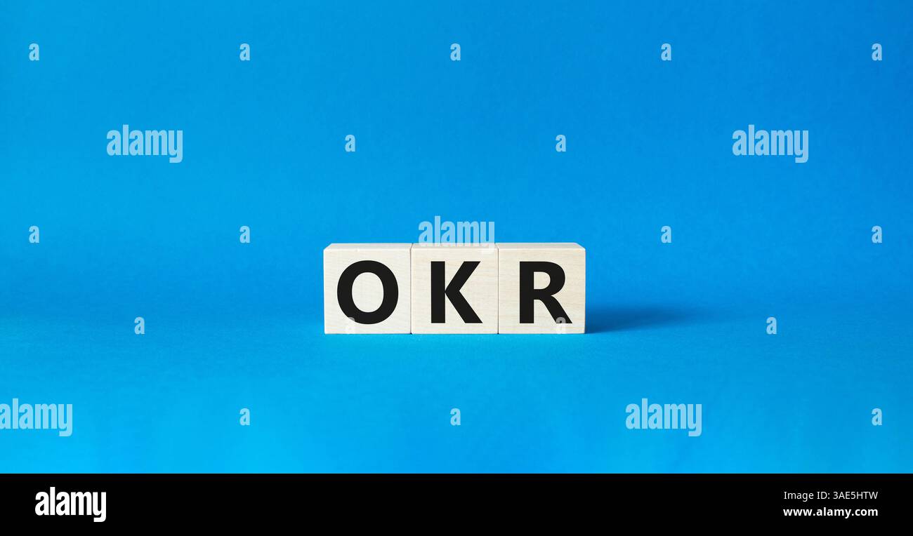 OKR objectives and key results symbol. Wooden cubes with words OKR ...