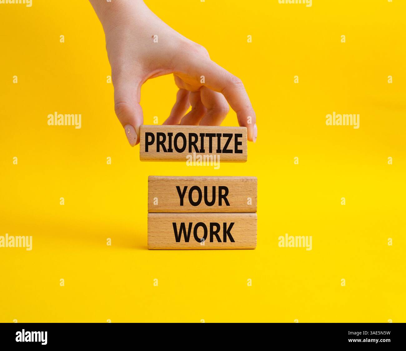 Priority symbol. Wooden blocks with words 'Prioritize your work ...