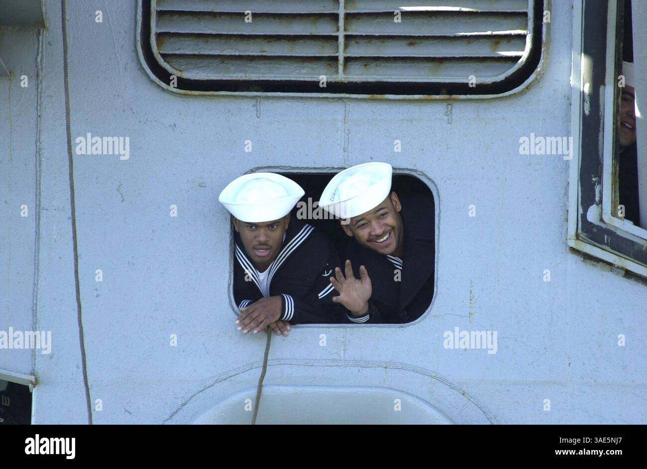 Dec 01, 2001; San Diego, CA, USA; Two sailors aboard the USS Ogden wave ...