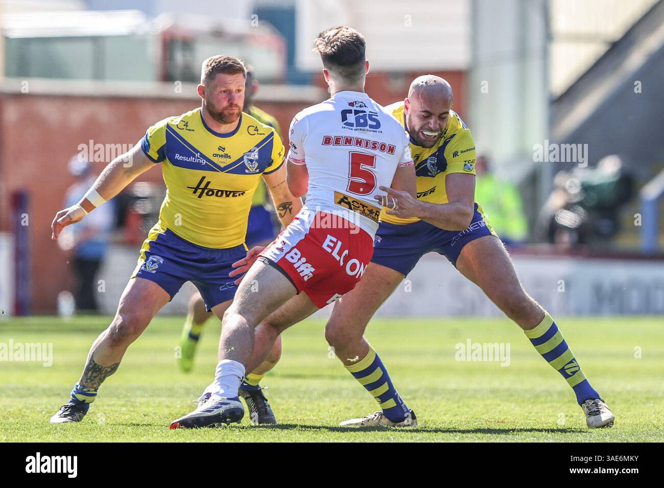 Jon Bennison of St. Helens is tackled by James Harrison of Warrington ...