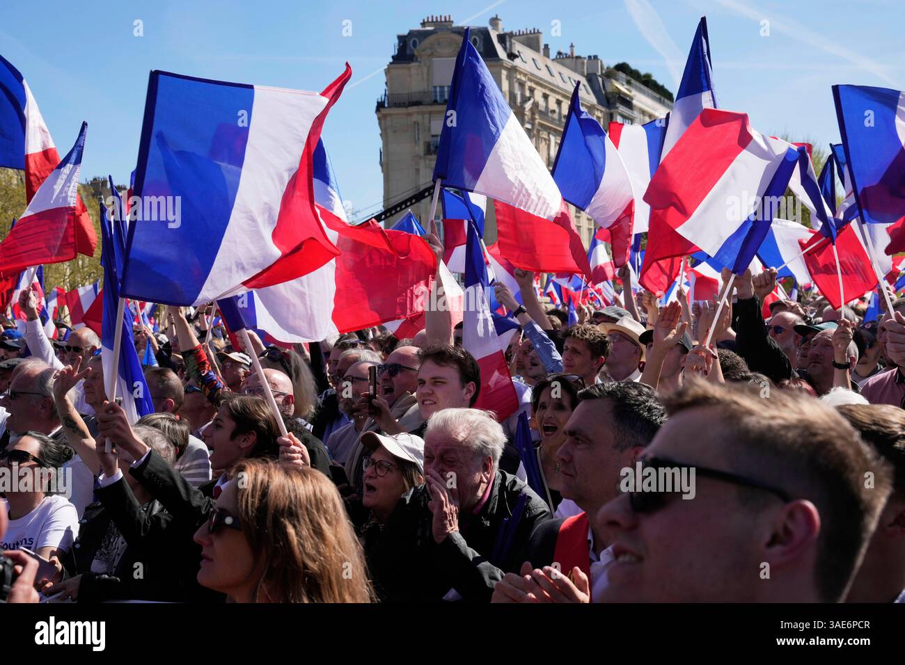 People shout slogans during the French far-right party national rally ...