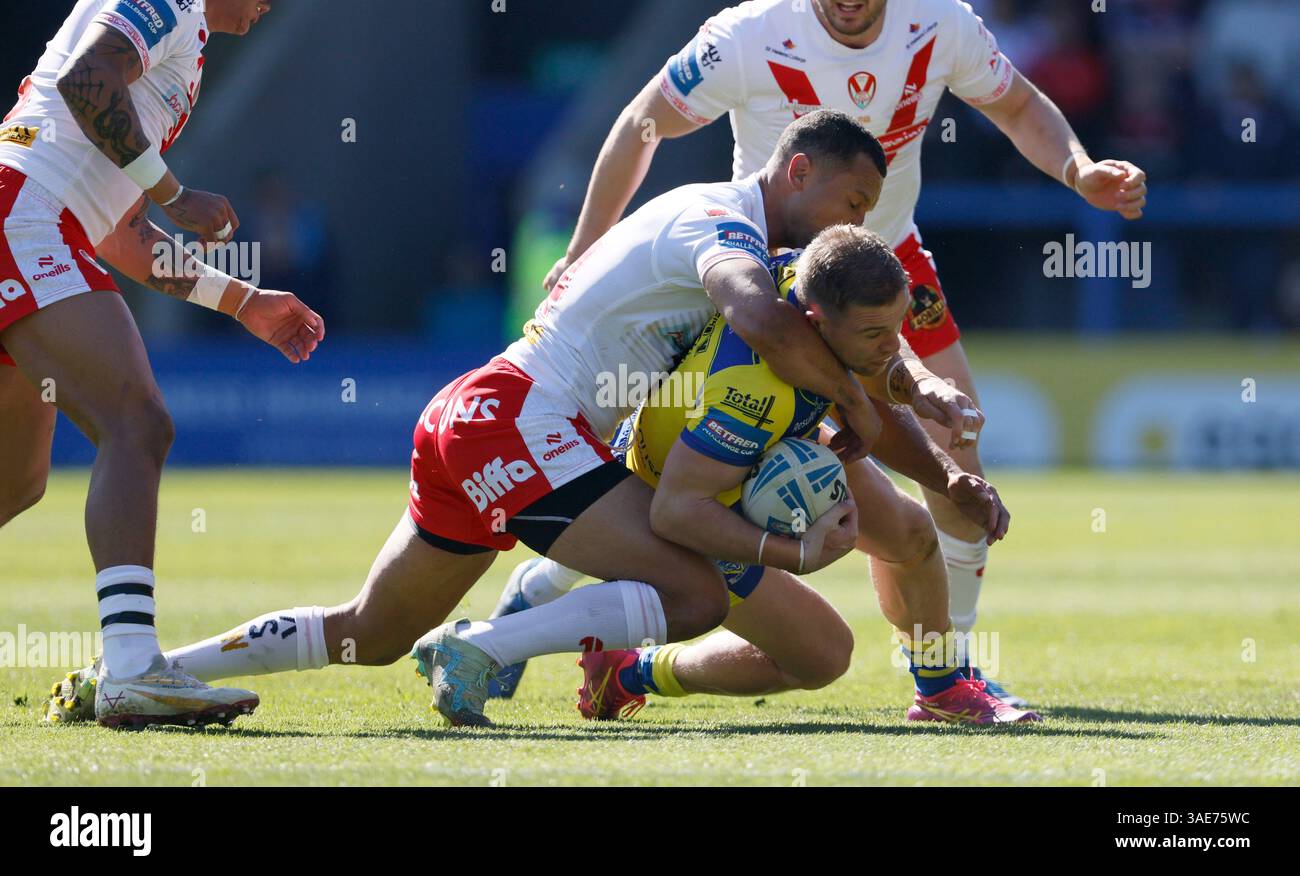Warrington Wolves' Matt Dufty (right) is tackled by St Helens' Moses ...