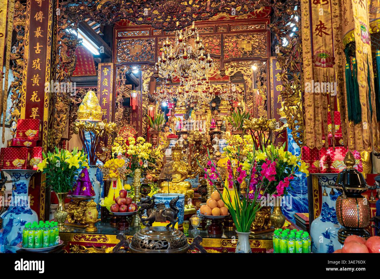 A vibrantly decorated altar in a Vietnamese temple, filled with ...