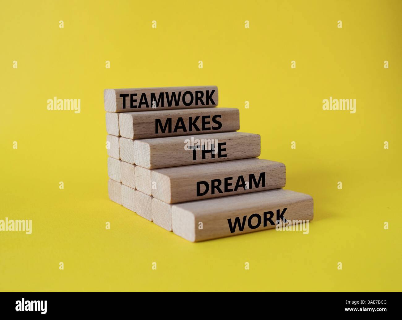 Teamwork symbol. Wooden blocks with words Teamwork makes the Dream work ...