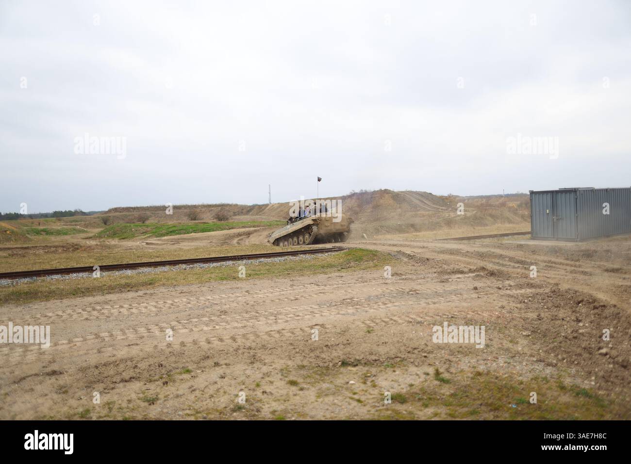 rear profile of commander and gunner directing action tank on a ...