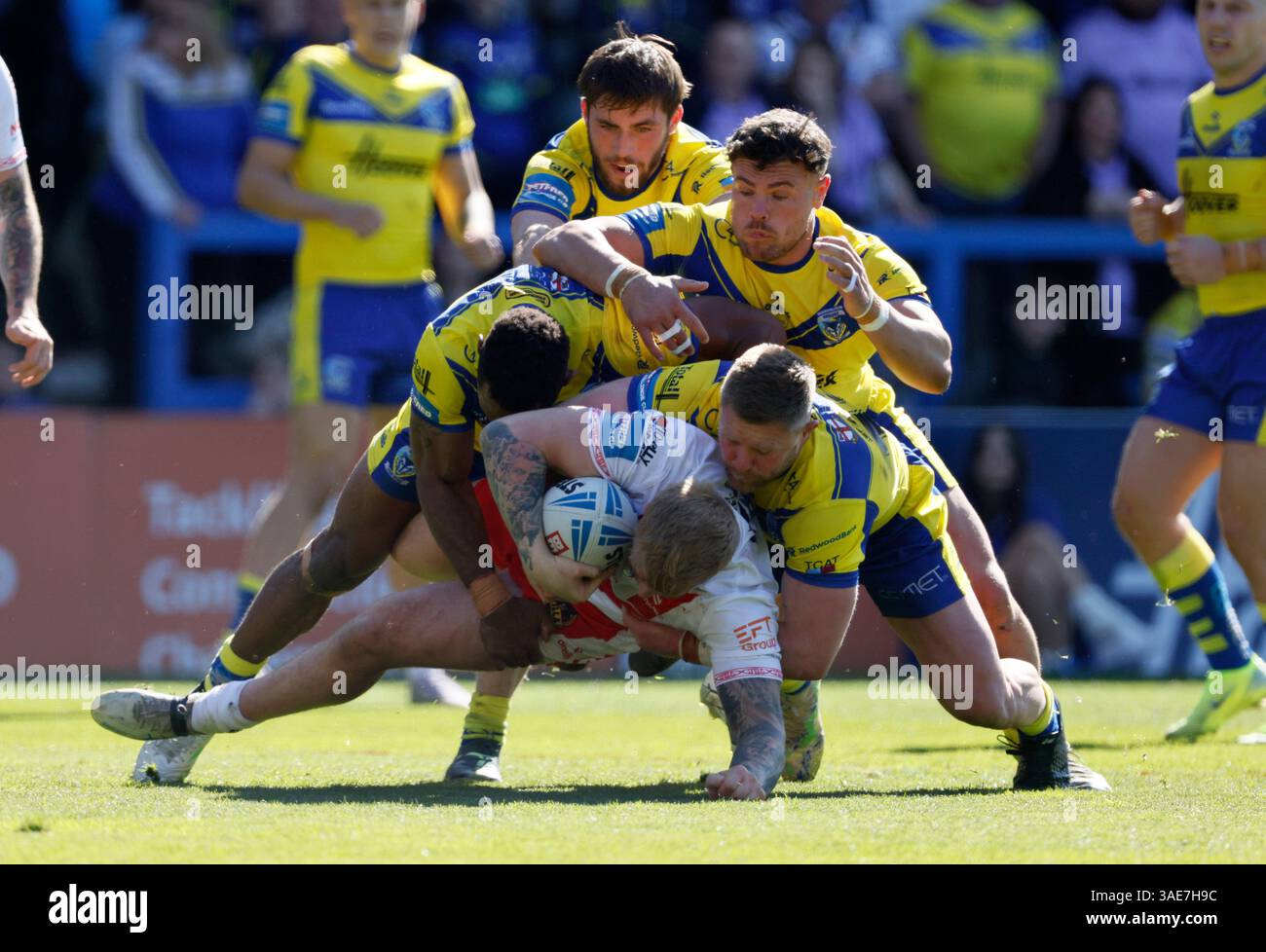 St Helens' George Delaney (bottom) is tackled during the Betfred ...