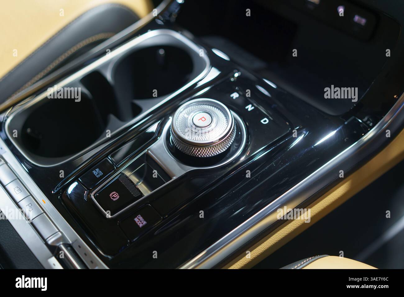 Close-up of a premium car console with a rotary gear shift knob ...