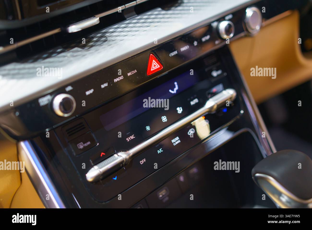 Modern dashboard featuring a hazard light, radio, and climate controls ...