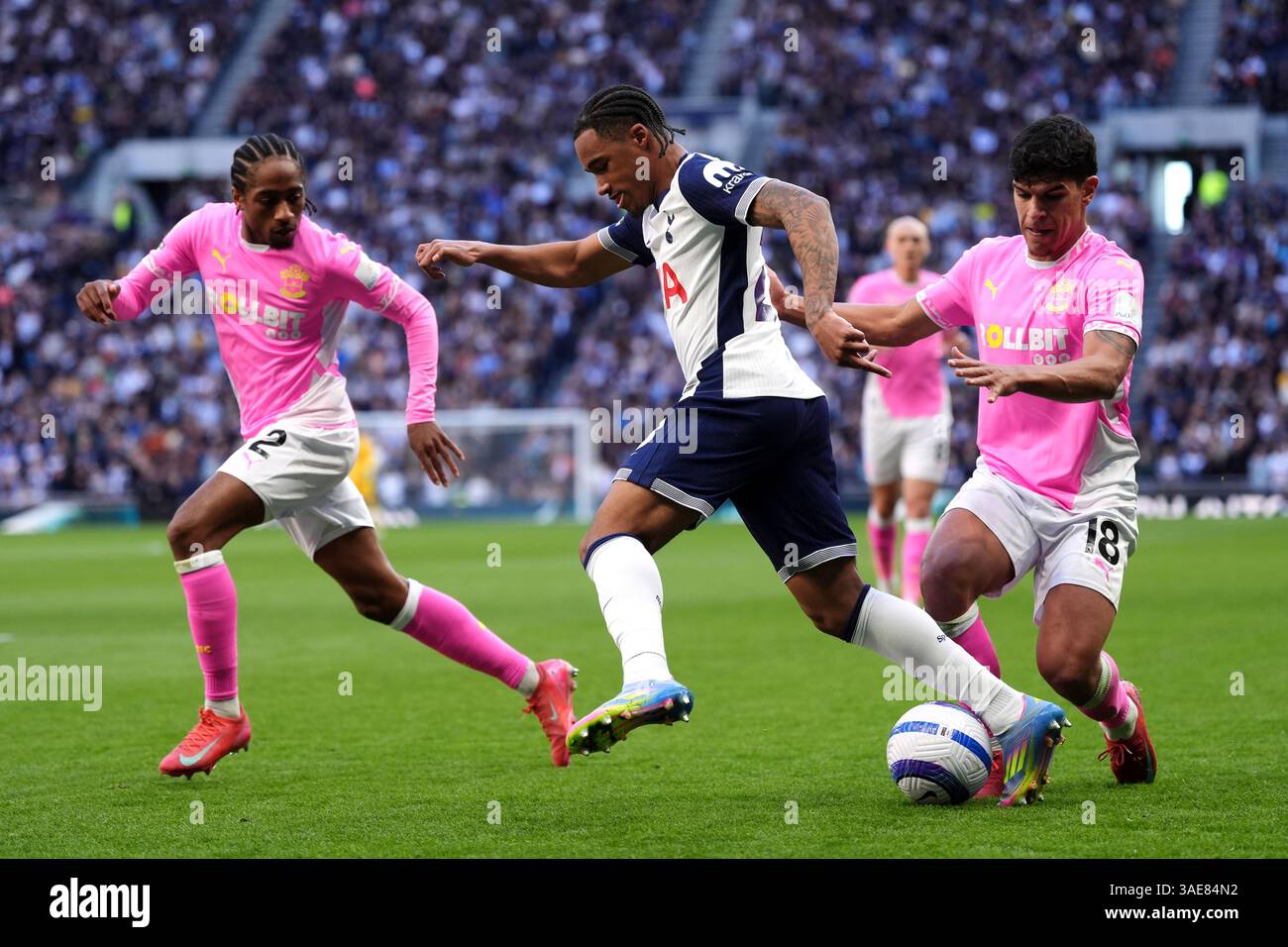 Tottenham Hotspur's Wilson Odobert (centre) battles for the ball with ...