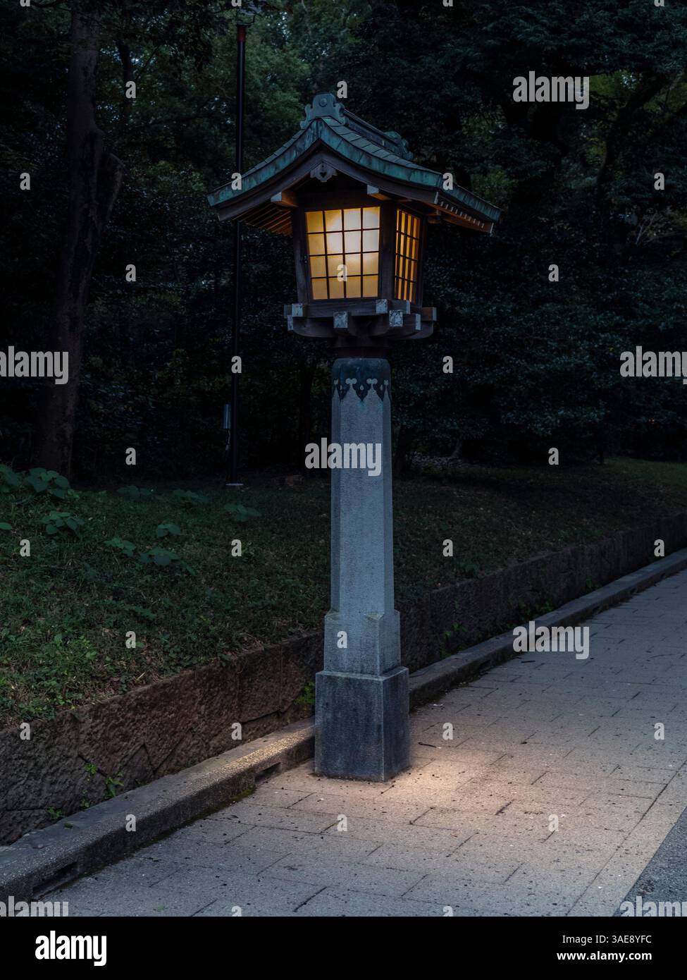 A japanese design street lantern on a path at the Meiji Jingu shrine in ...