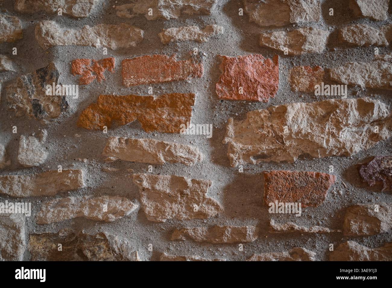 Natural stone wall with granite and brick grouted with trass cement ...