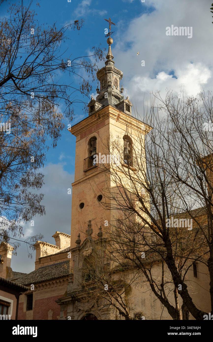 A tall church tower with a cross on top is surrounded by trees Stock ...