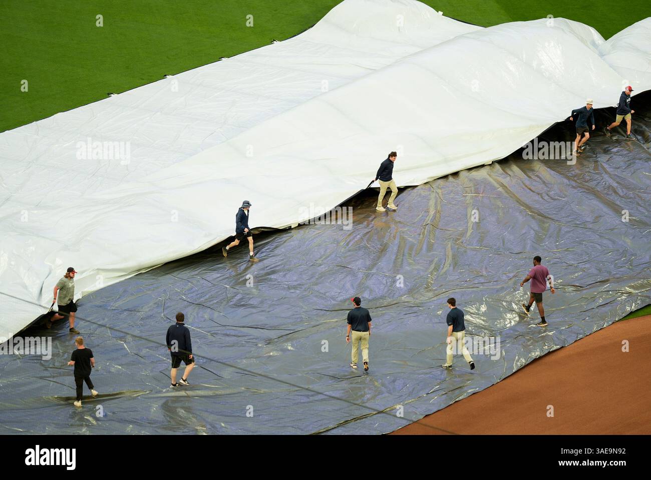 Ground crews tarp the field at Truist Park ahead of inclimate weather ...
