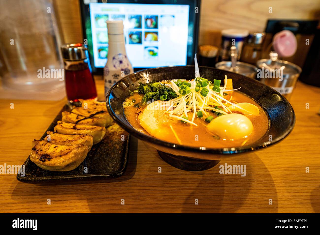 Miso-flavored tamago ramen with sliced pork and egg along with a side ...