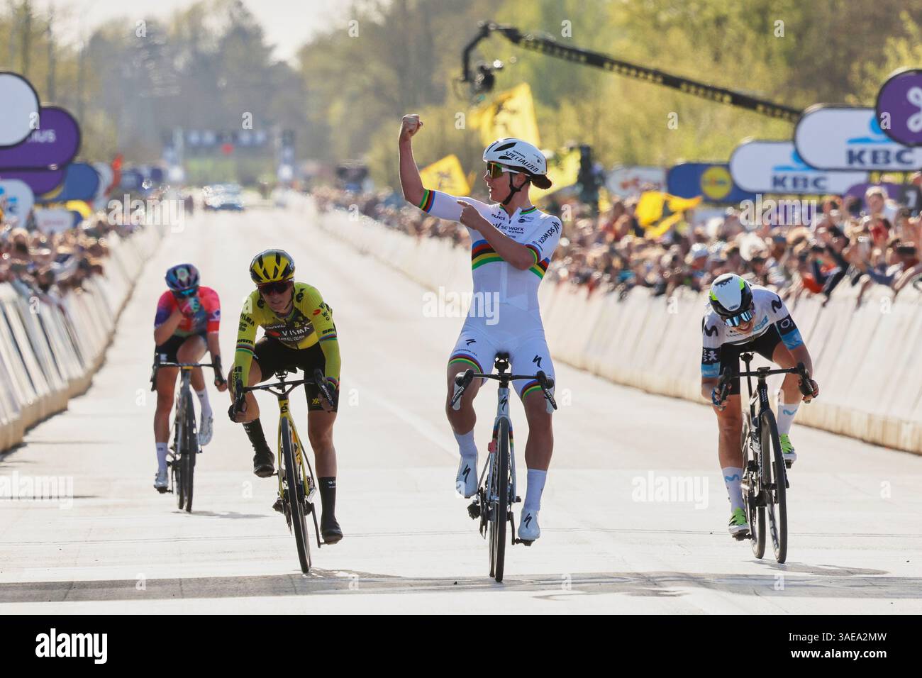 Belgium's Lotte Kopecky, center, of the Team SD Worx-Protime, crosses the finish line to win the ...