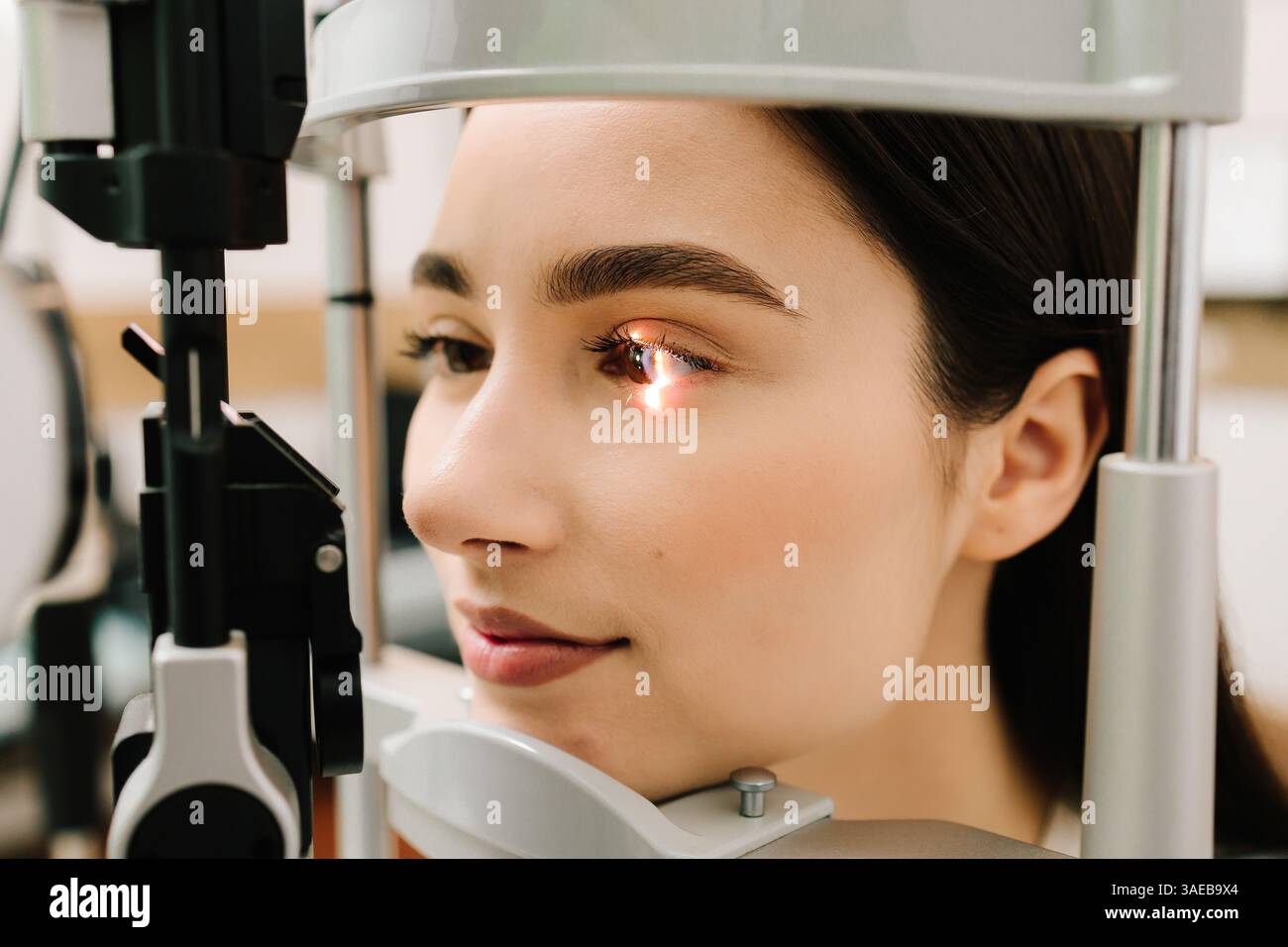 Light on eye from slit lamp for examination eyes and cornea of girl ...